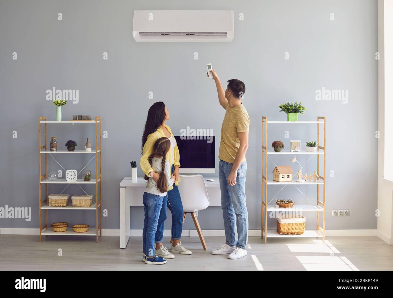 The family uses air conditioning at home. Back view Stock Photo - Alamy