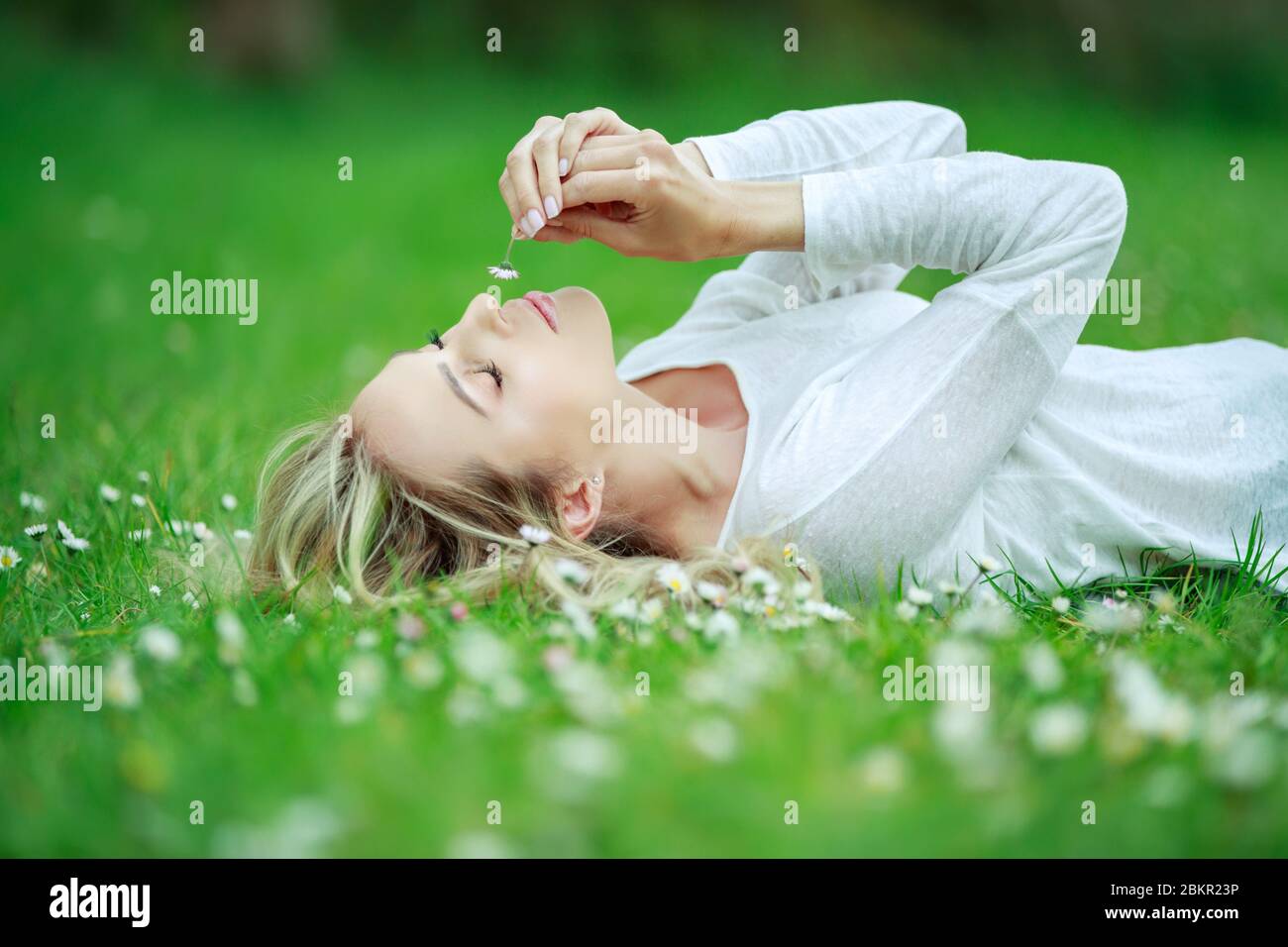 Beautiful woman with a flower Stock Photo - Alamy