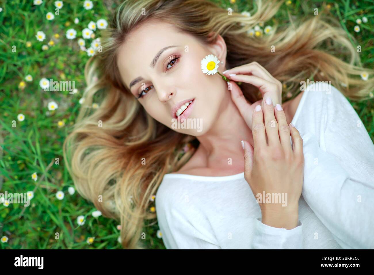 Beautiful woman with a flower Stock Photo - Alamy