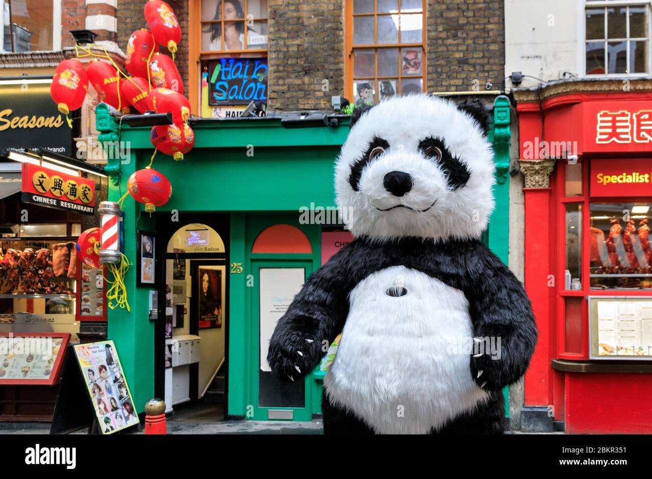 A giant Panda figure outside shops and Restaurants in Wardour Street in ...
