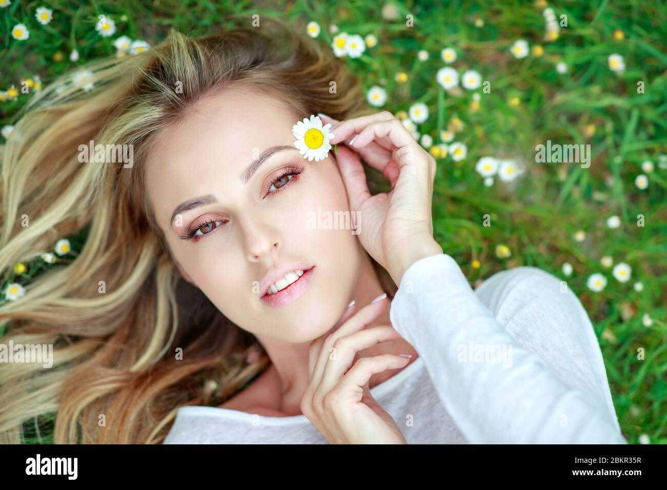 Beautiful woman with a flower Stock Photo - Alamy