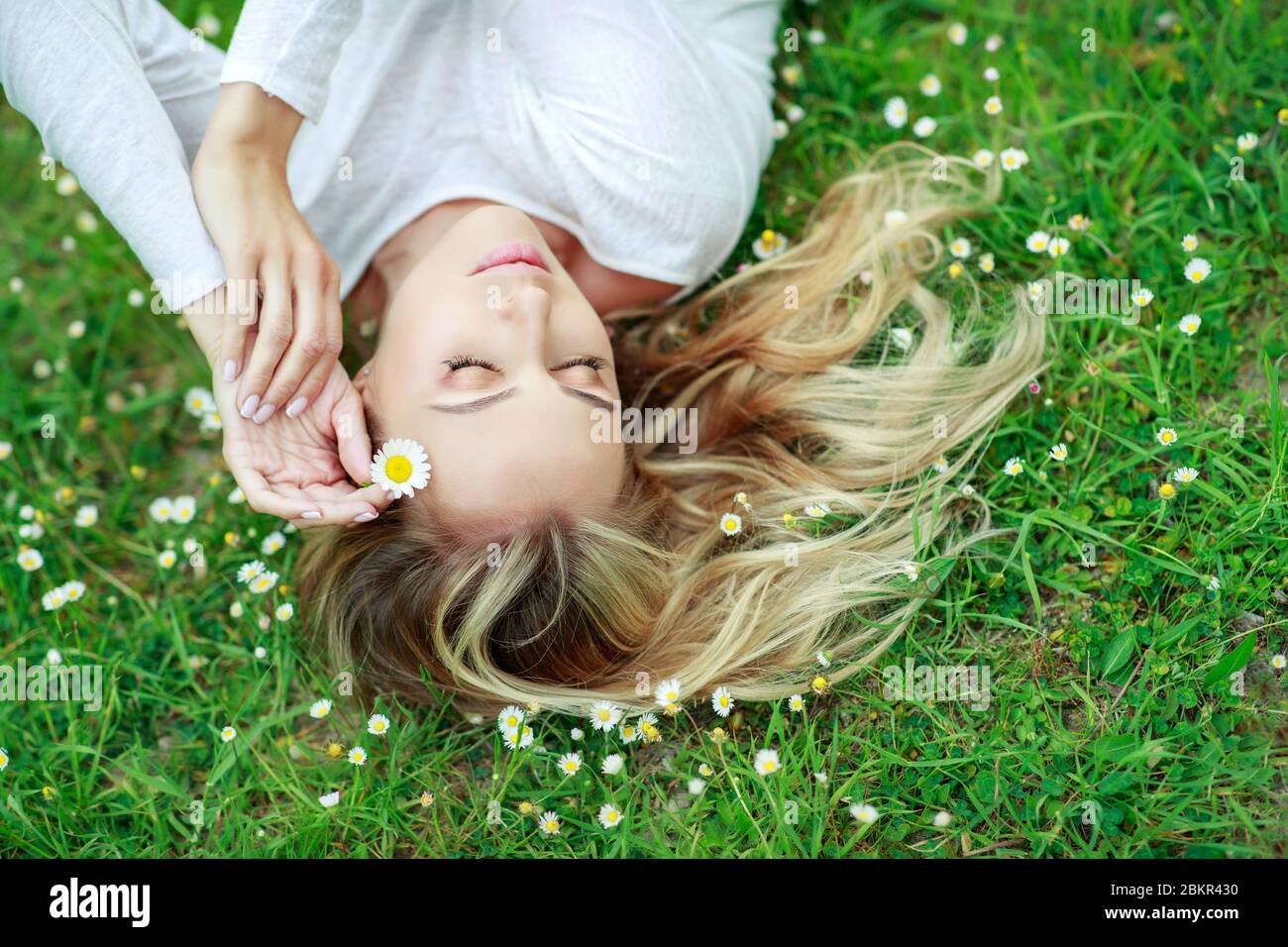 Beautiful woman with a flower Stock Photo - Alamy