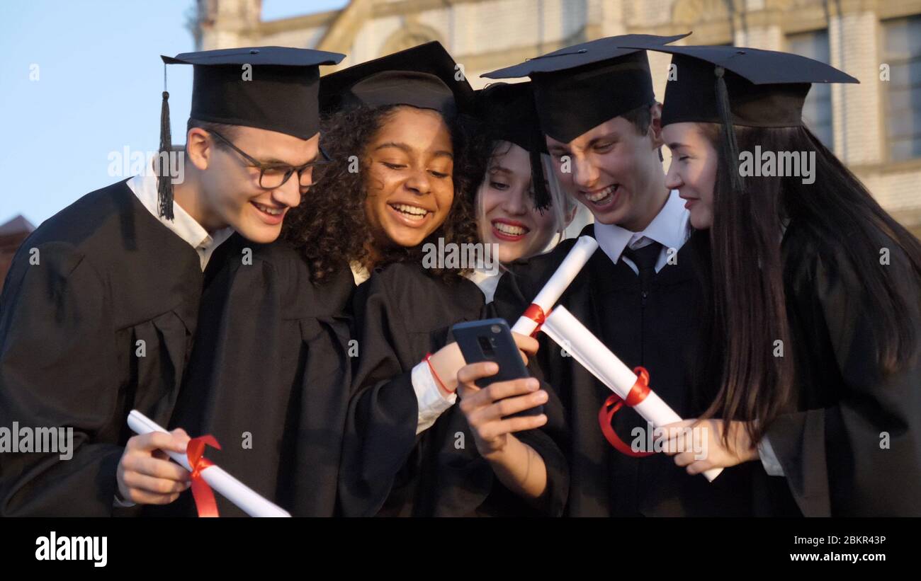 Happy group of students on graduation day laughing at something Stock ...