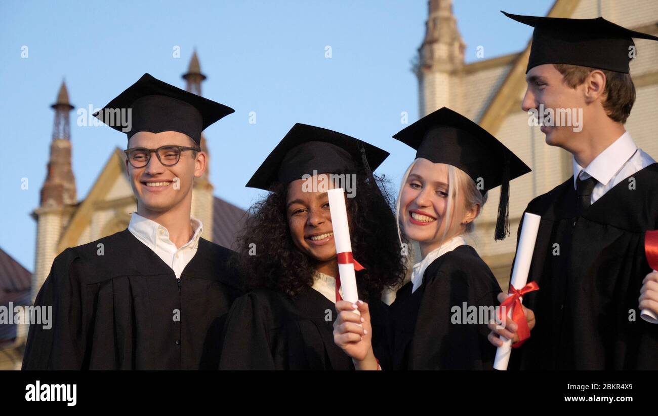 Graduating students smiling and laughing with diplomas Stock Photo - Alamy
