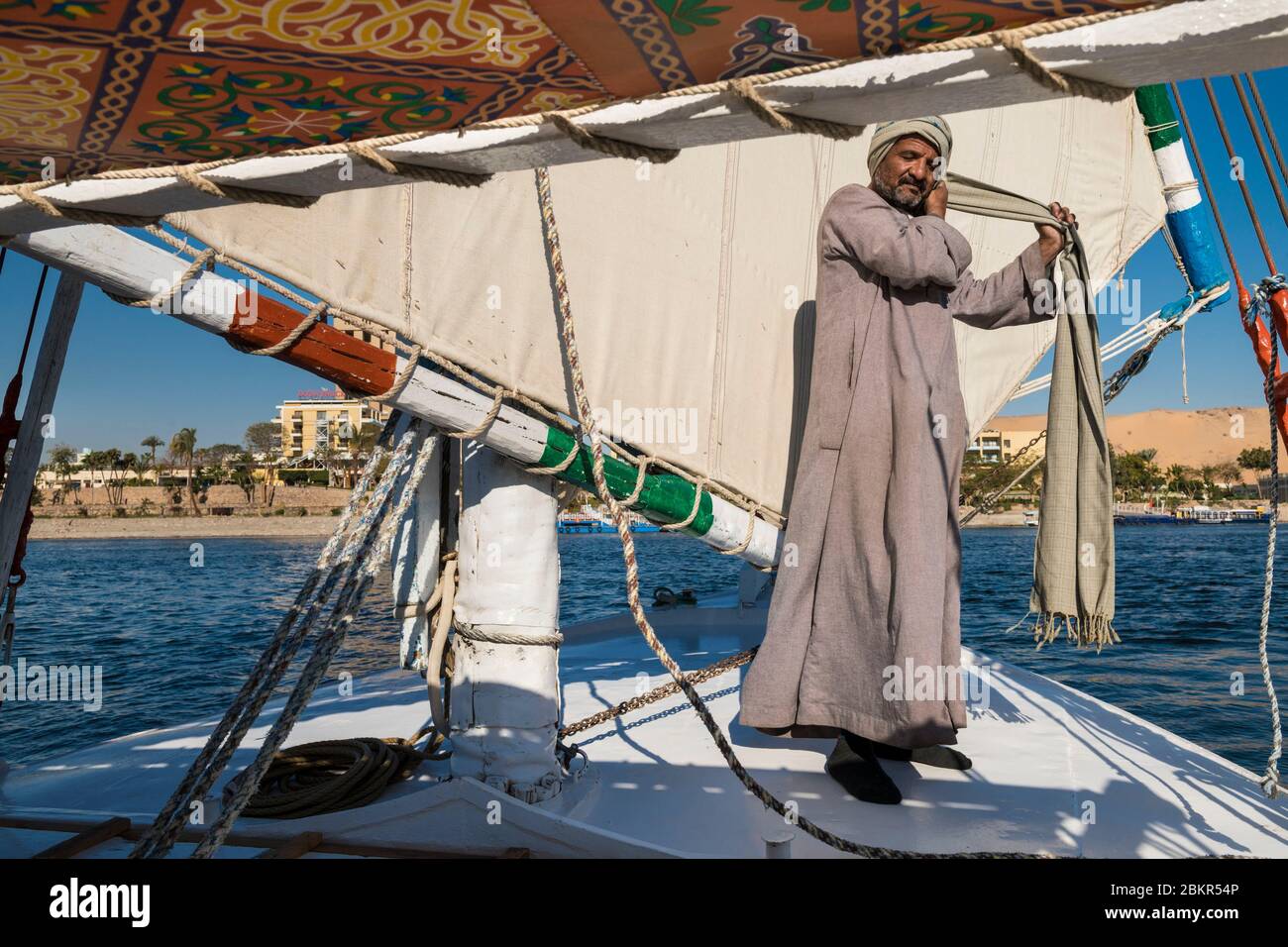 Egypt, Upper Egypt, near Elephanine island, sailor on a felucca sailing ...