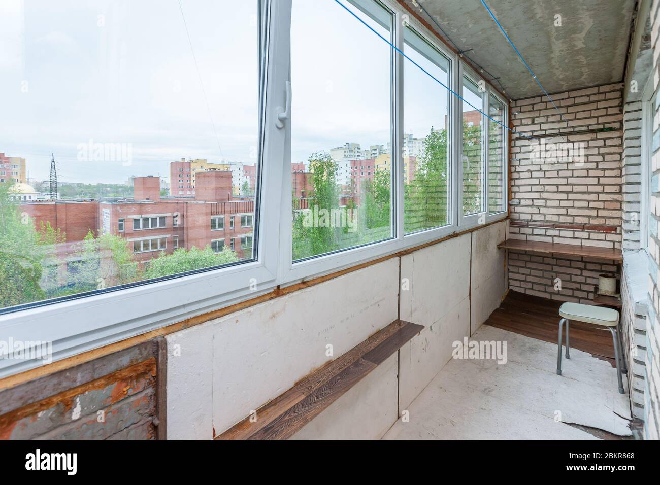 Small old common open balcony interior in high residential apartment ...