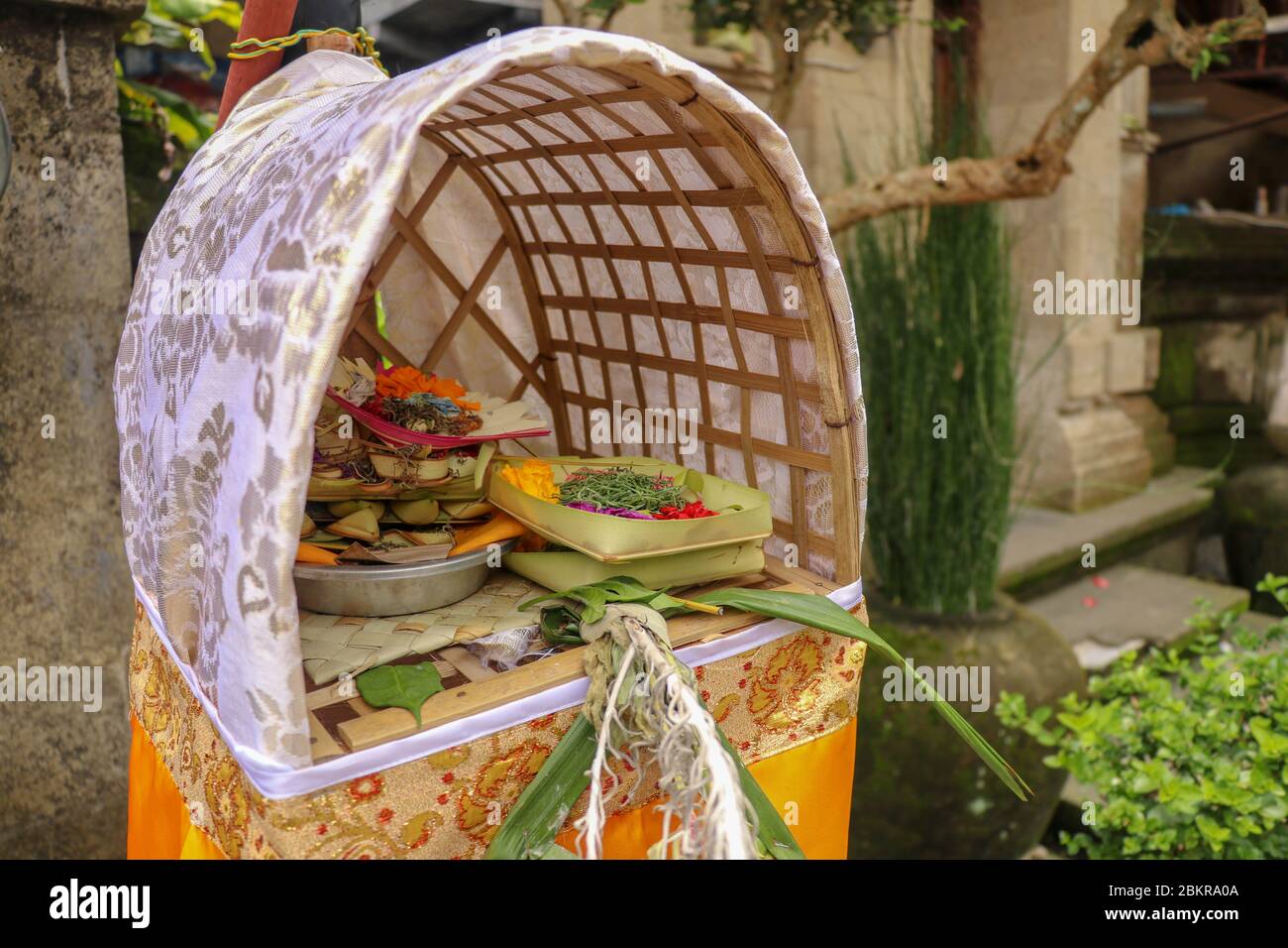 Altar woven from bamboo wicker, covered with white cloth with gold ...