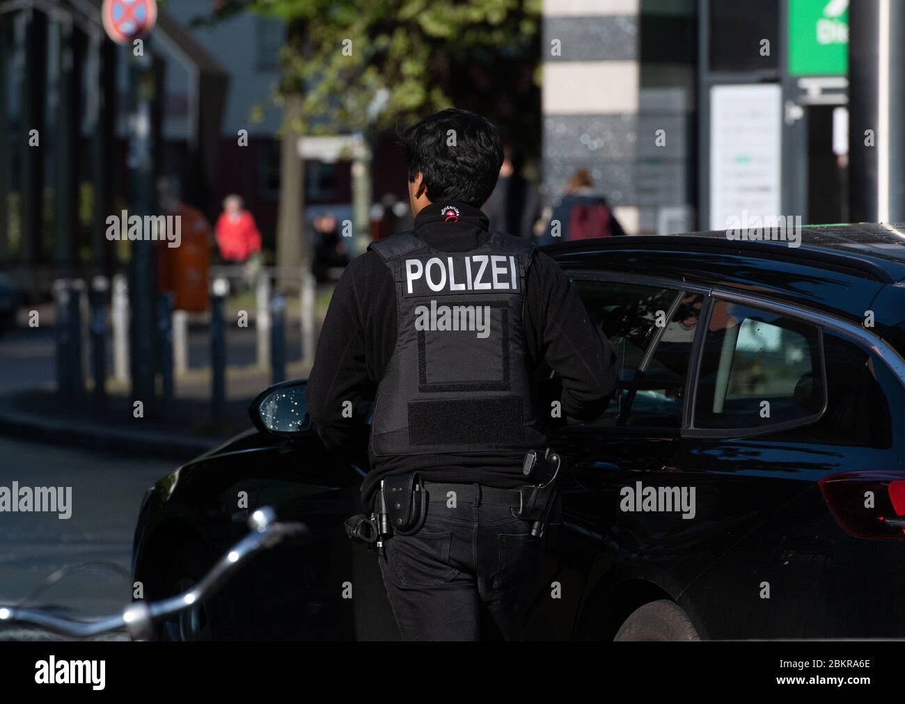 Berlin, Germany. 05th May, 2020. A cop gets into his car. Two men armed ...