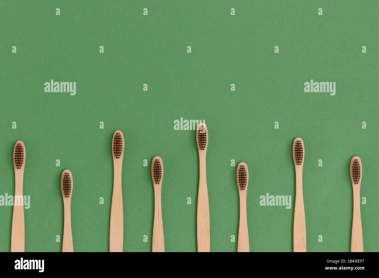 Frame made of toothbrushes on a green background. Plastic free concept ...