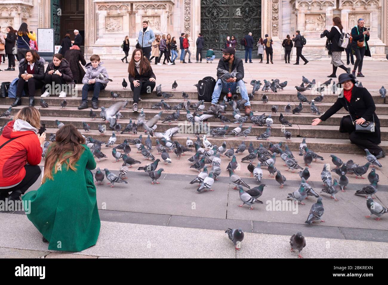 Italy, Lombardy, Milan, Piazza del Duomo, pigeons fed in front of the ...