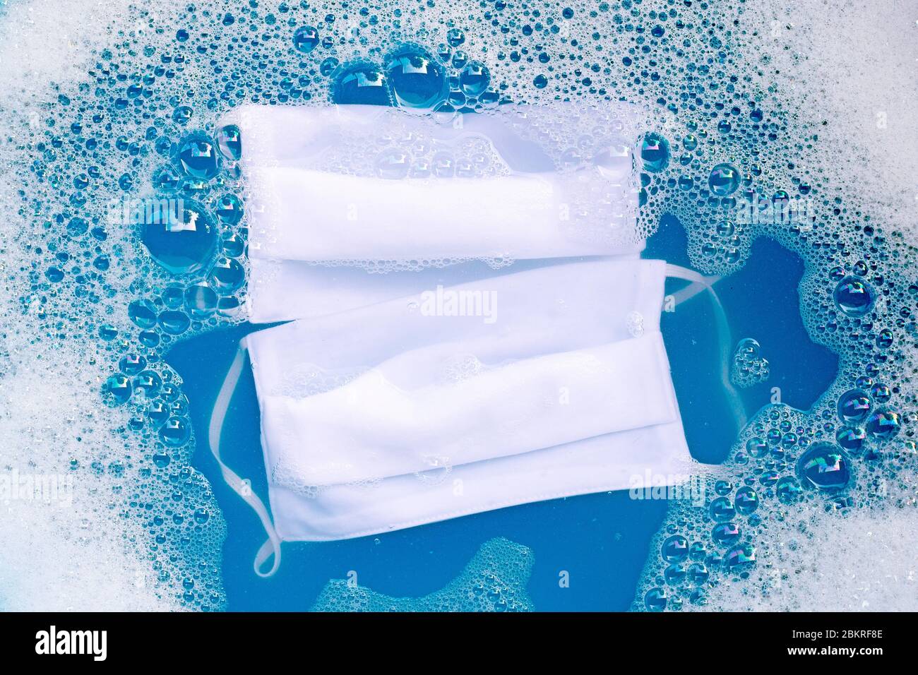 Cloth masks soak in powder detergent water dissolution before washing ...