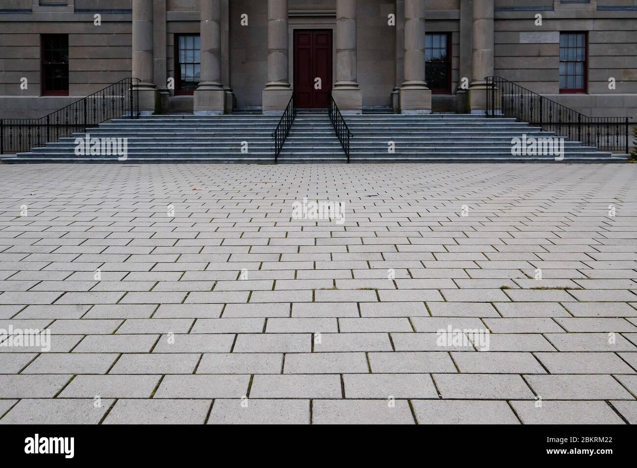 A wide entrance to a government courthouse building with tall pillars ...