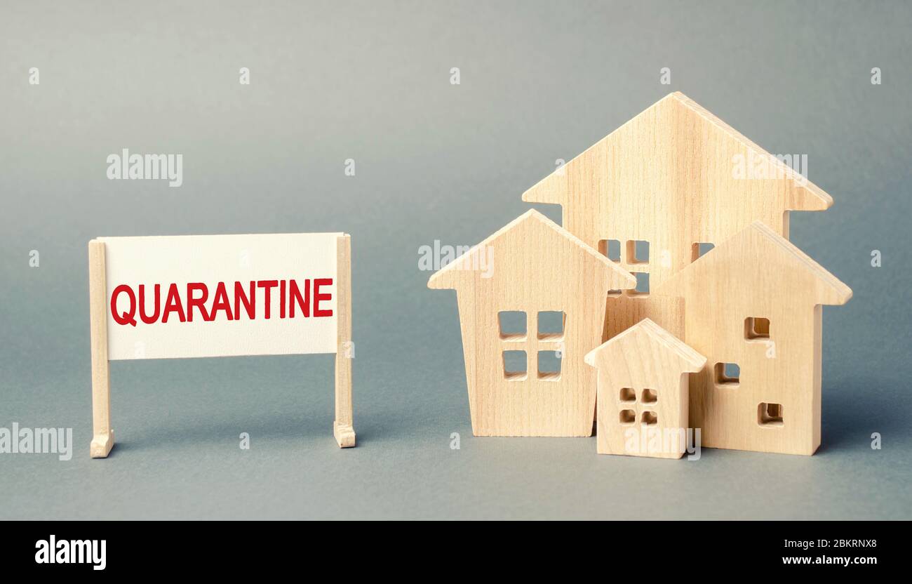Wooden houses and the inscription Quarantine on an easel. Coronavirus ...