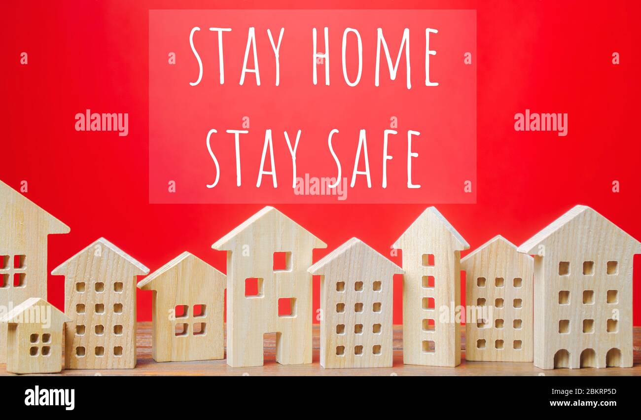 Miniature wooden houses with the words Stay home stay safe. Coronavirus ...