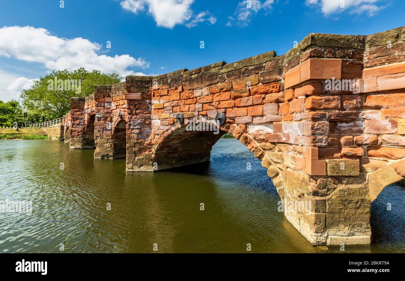 The red sandstone road bridge over the river Avon at Eckington wharf in ...