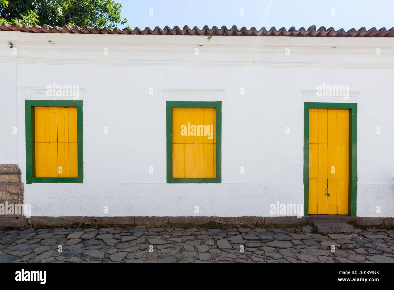 Street and old portuguese colonial houses in historic downtown in ...