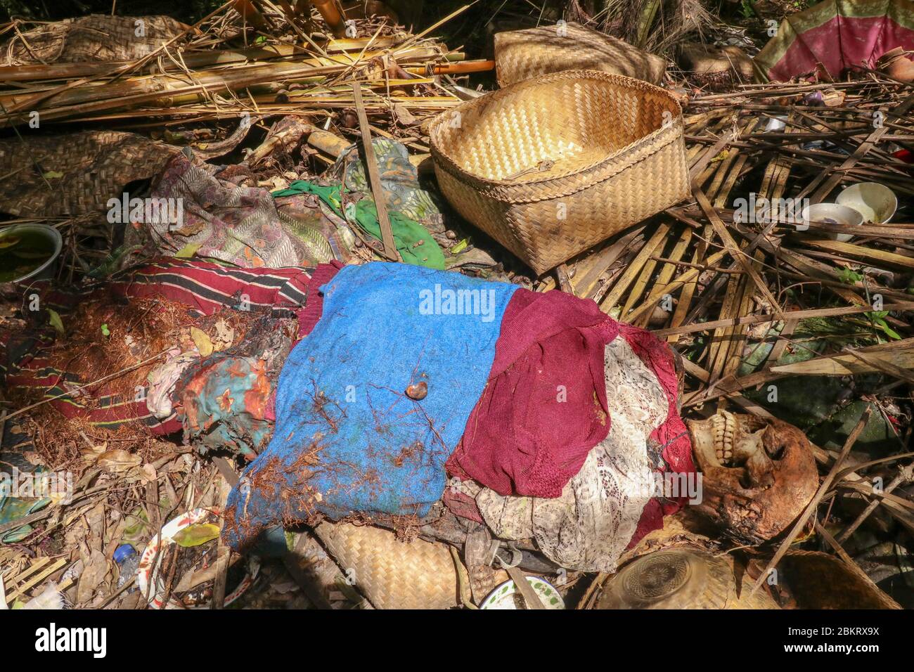 Close up of body of dead man dressed in colorful cloth lying on ground ...