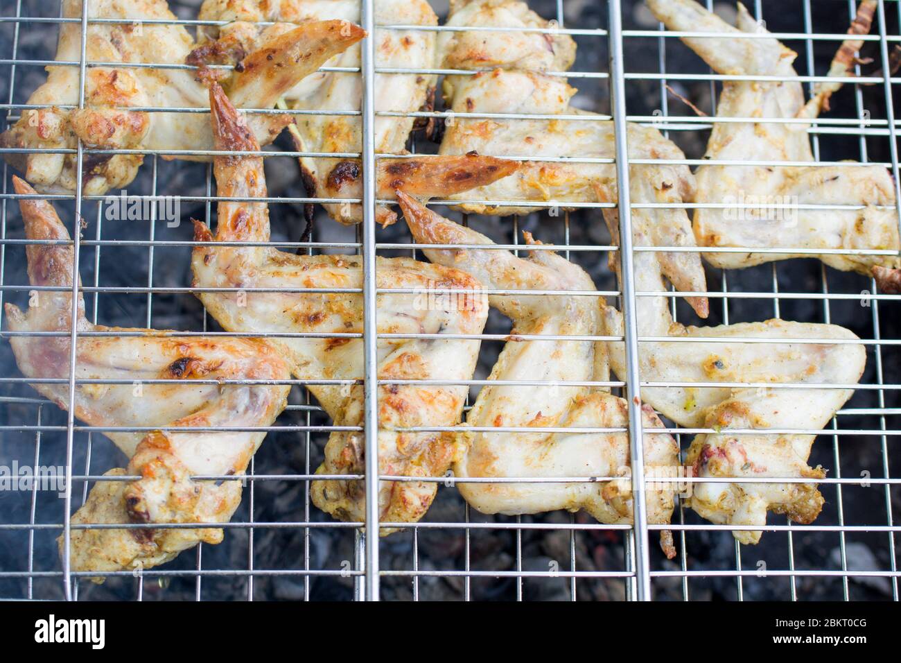 Fried chicken wings on barbecue grill. Fast food product Stock Photo ...