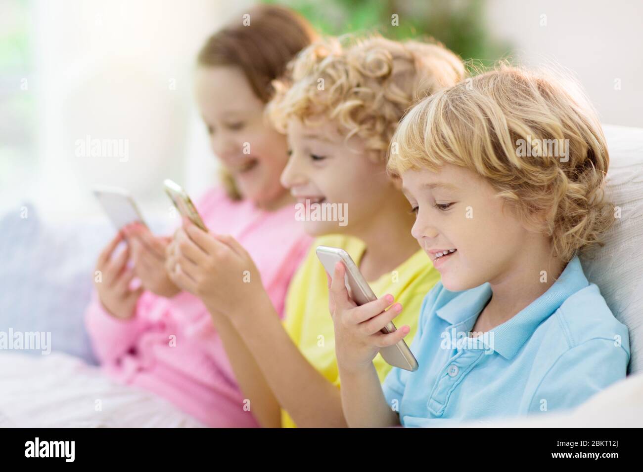 Kids with mobile phone. Child with tablet computer watching movie or ...