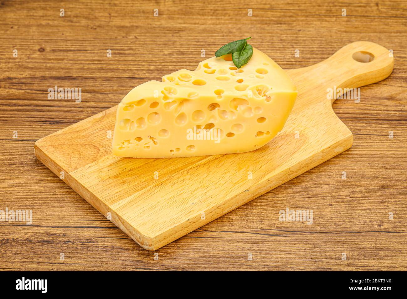 Maasdam cheese - dairy yellow triangle with holes Stock Photo - Alamy