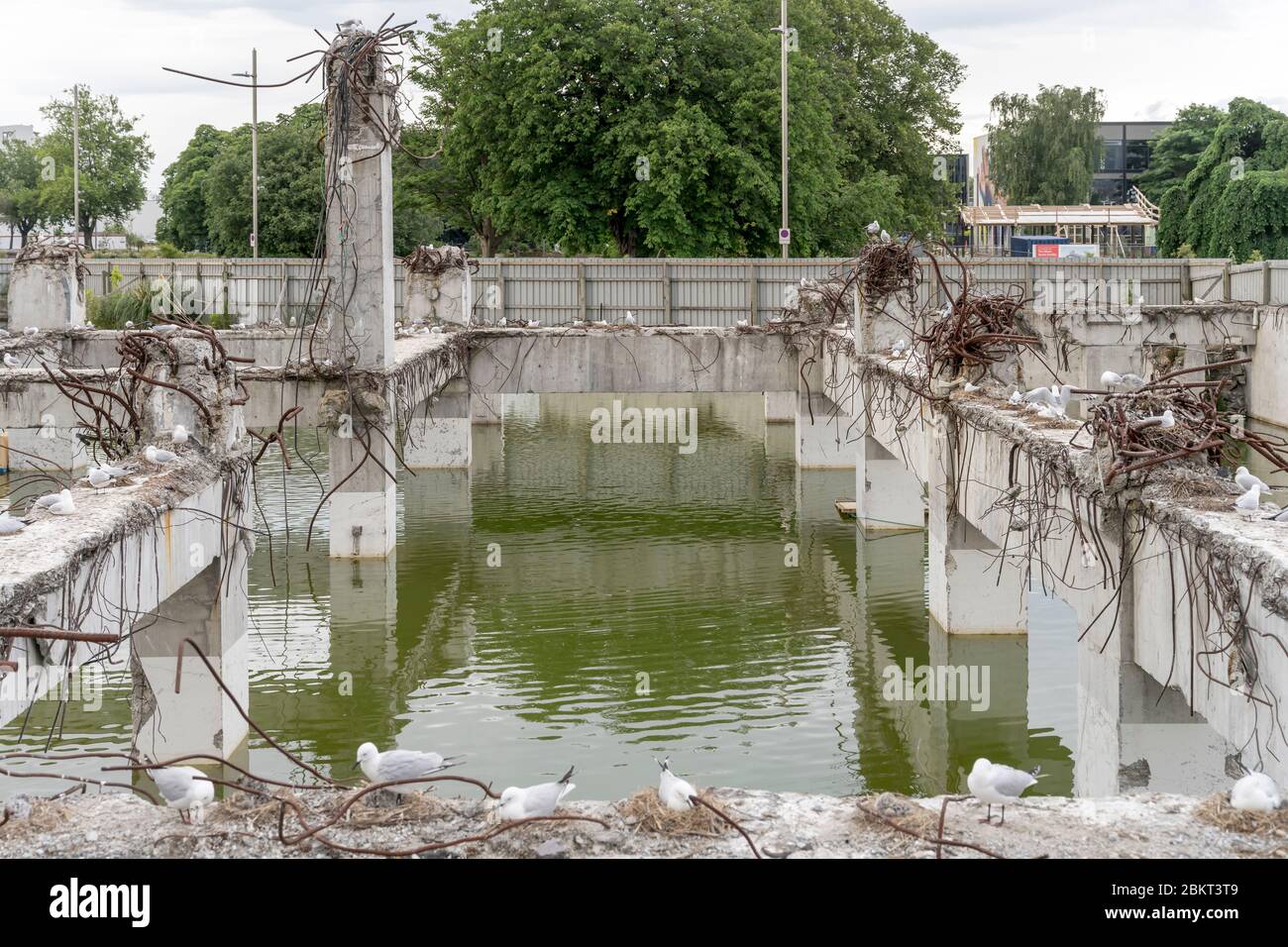 cityscape with flooded ruins of collapsed concrete building and ...