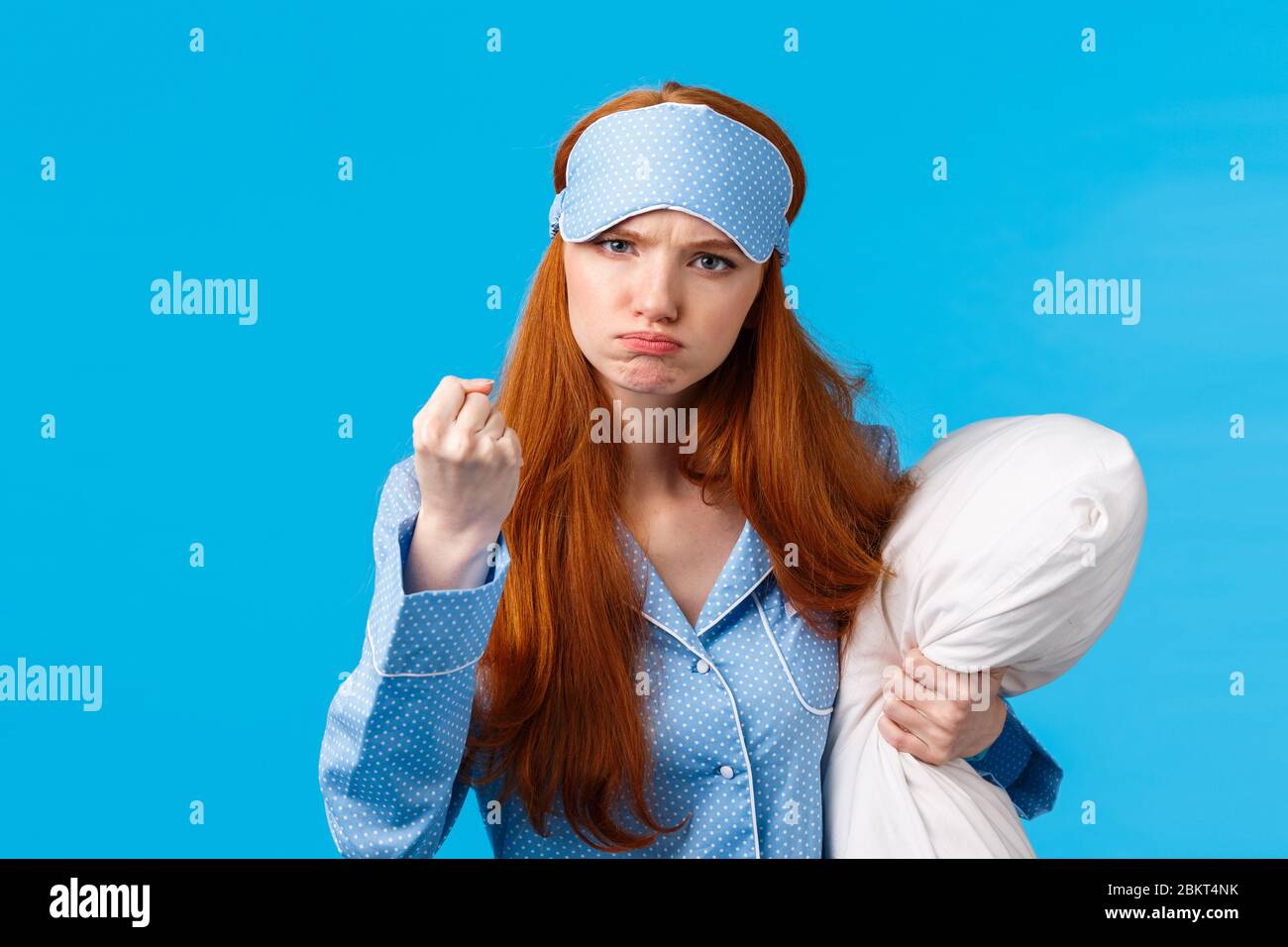 Who disturbed my sleep. Mad and displeased, angry grumpy redhead woman ...