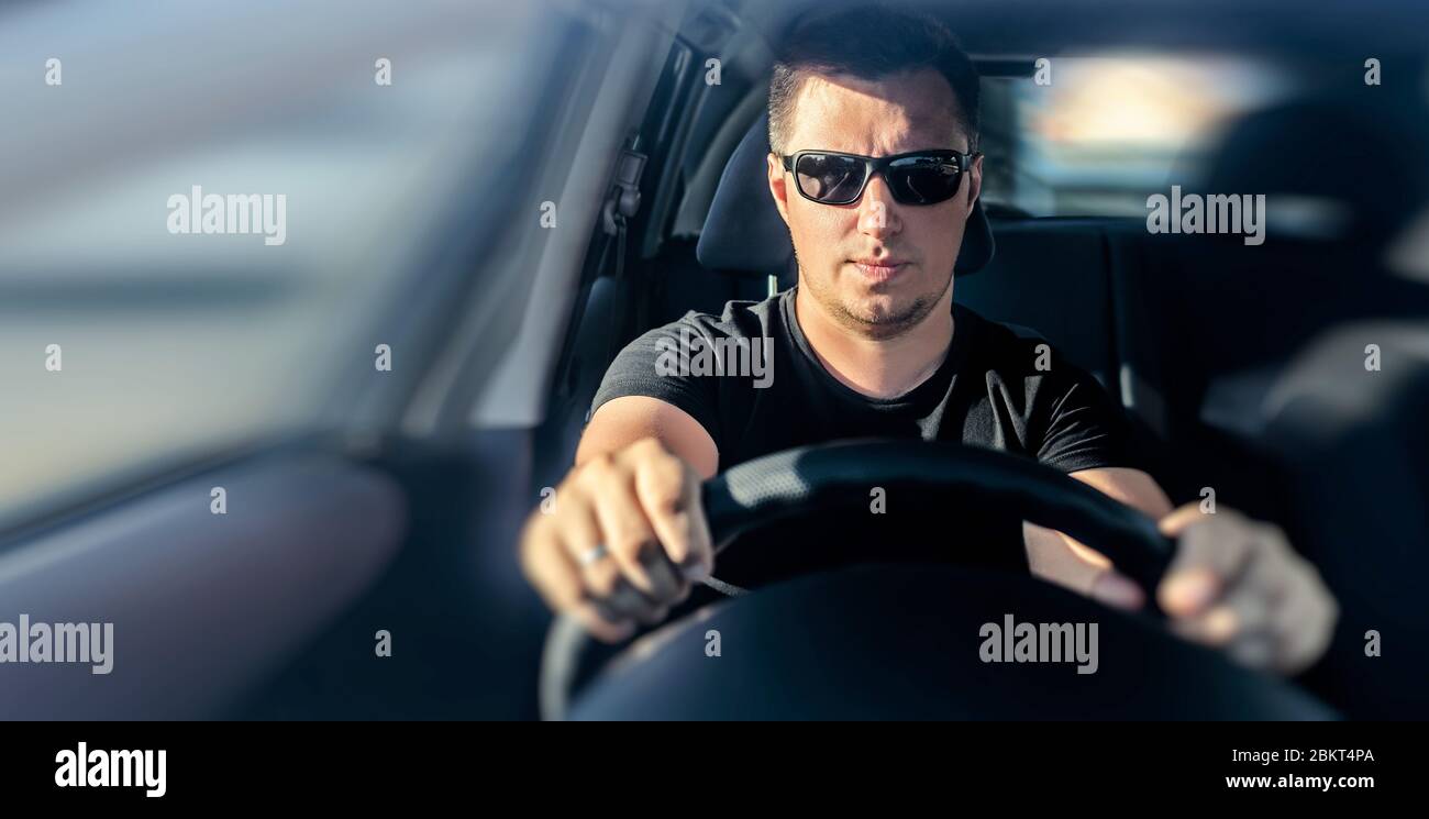 Handsome man driving his car Stock Photo - Alamy