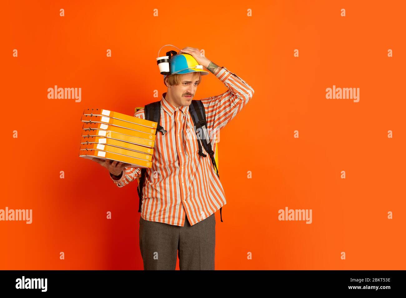 Sad, tired holding pizza boxes. Emotions of caucasian deliveryman ...