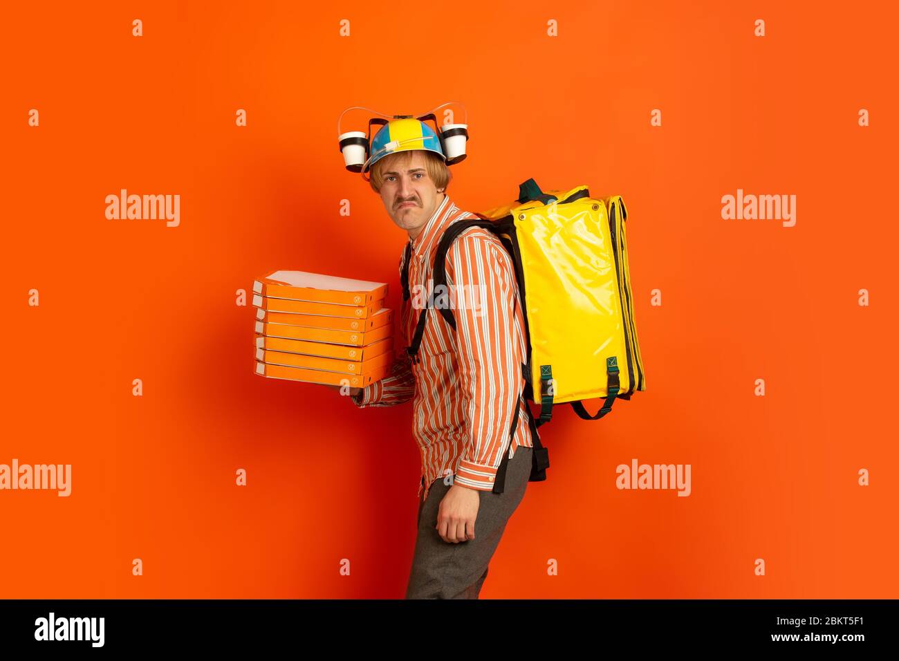 Sad, angry holding pizza boxes. Emotions of caucasian deliveryman ...