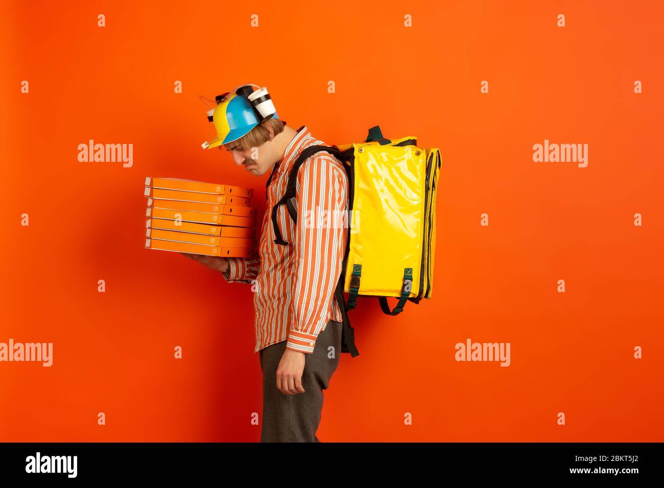 Sad, angry holding pizza boxes. Emotions of caucasian deliveryman ...