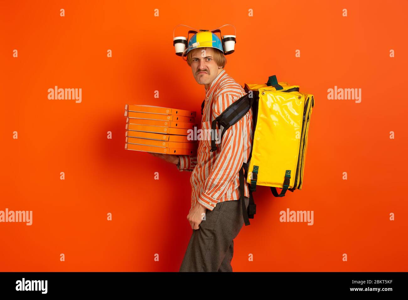 Sad, angry holding pizza boxes. Emotions of caucasian deliveryman ...