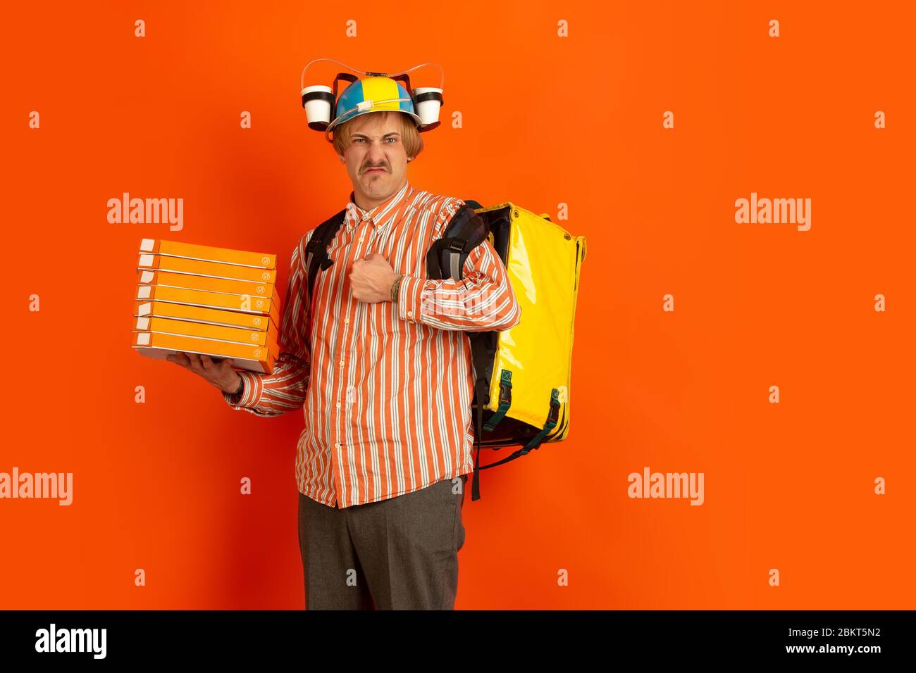 Sad, angry holding pizza boxes. Emotions of caucasian deliveryman ...