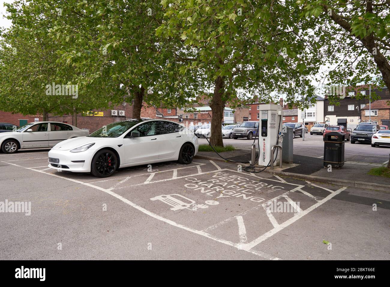 Tesla model 3 electric car plugged into charging station Stock Photo ...