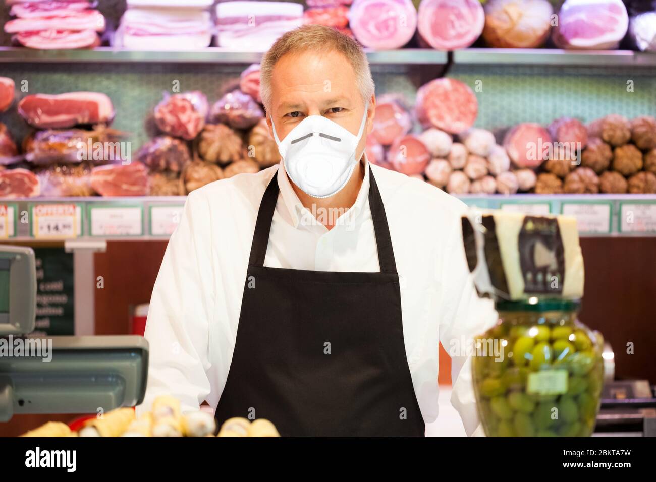 Shopkeeper smiling in a grocery store Stock Photo - Alamy