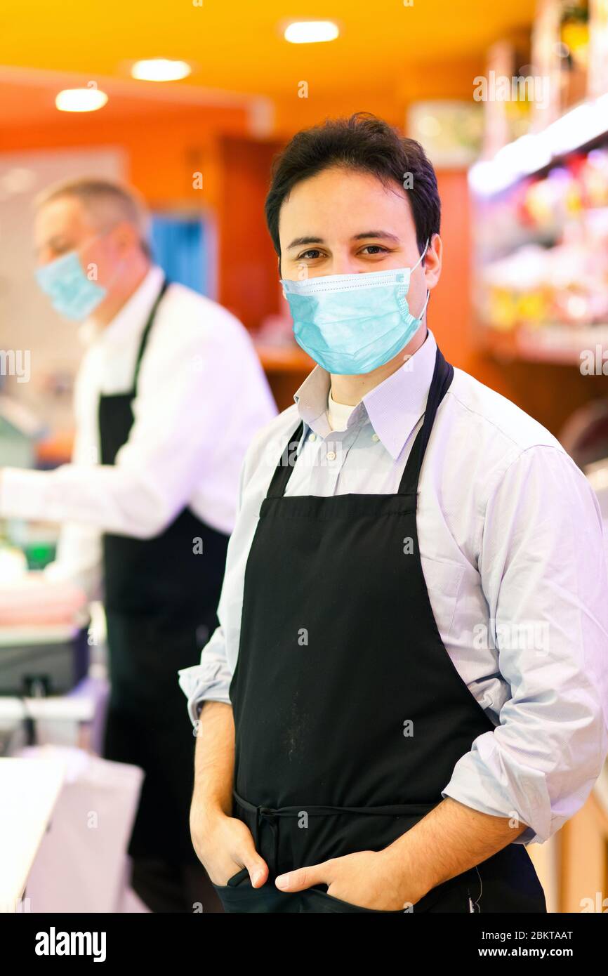 Shopkeeper working in his grocery store Stock Photo - Alamy