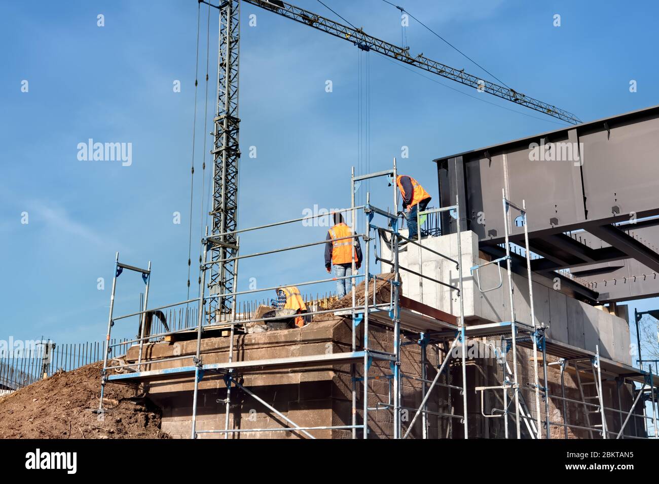 Construction site for a bridge, machines and building material under a ...