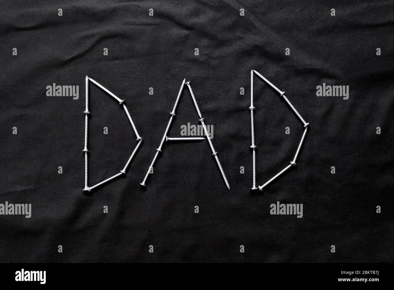 The Word Dad Spelled Out With Screws on a Black Background Stock Photo ...