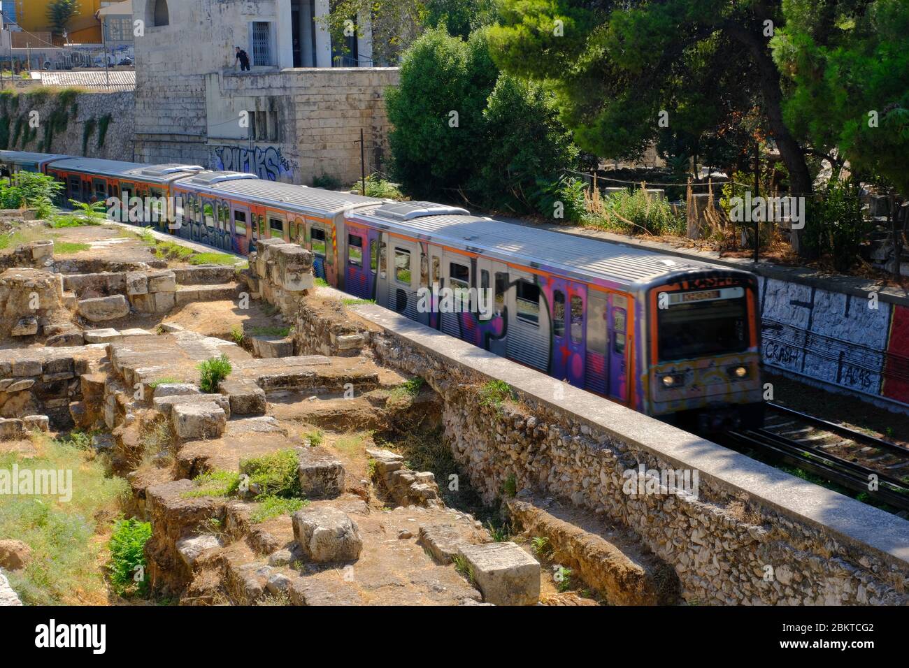 A modern metro train travels through the ancient Agora in Athens ...