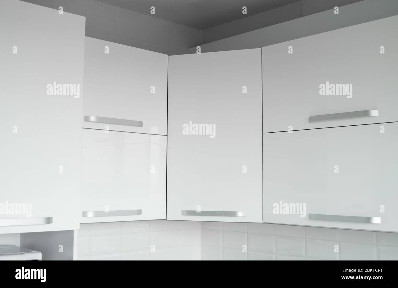 White lacquered kitchen facades on a comfortable kitchen. Modern white ...