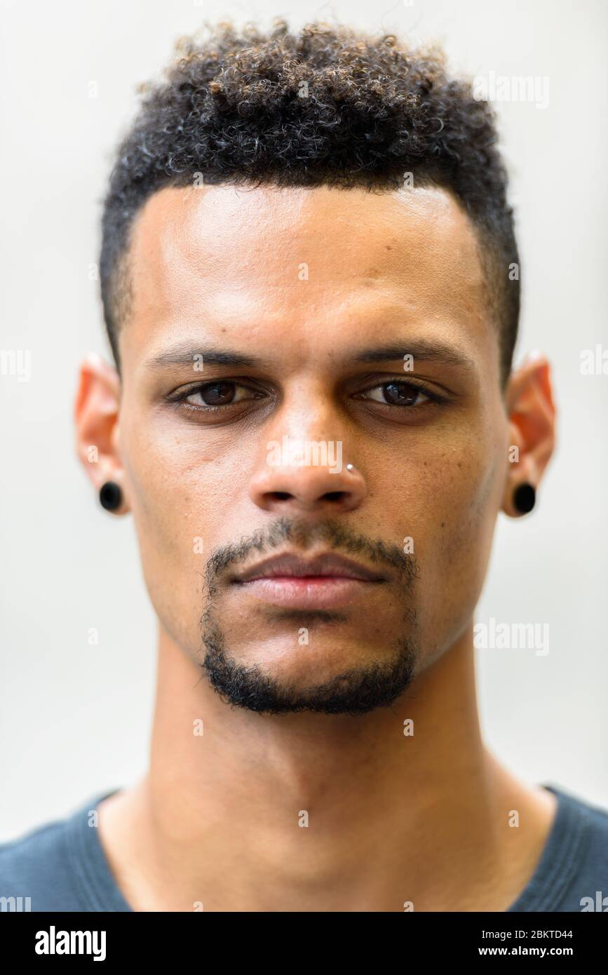 Face of young handsome bearded African man outdoors Stock Photo - Alamy