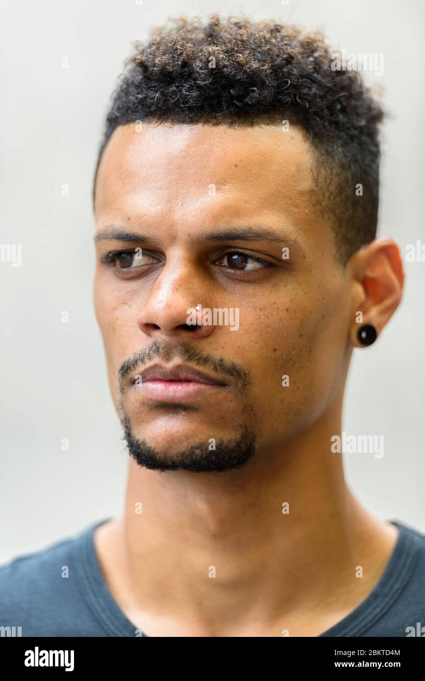 Face of young handsome bearded African man thinking outdoors Stock ...