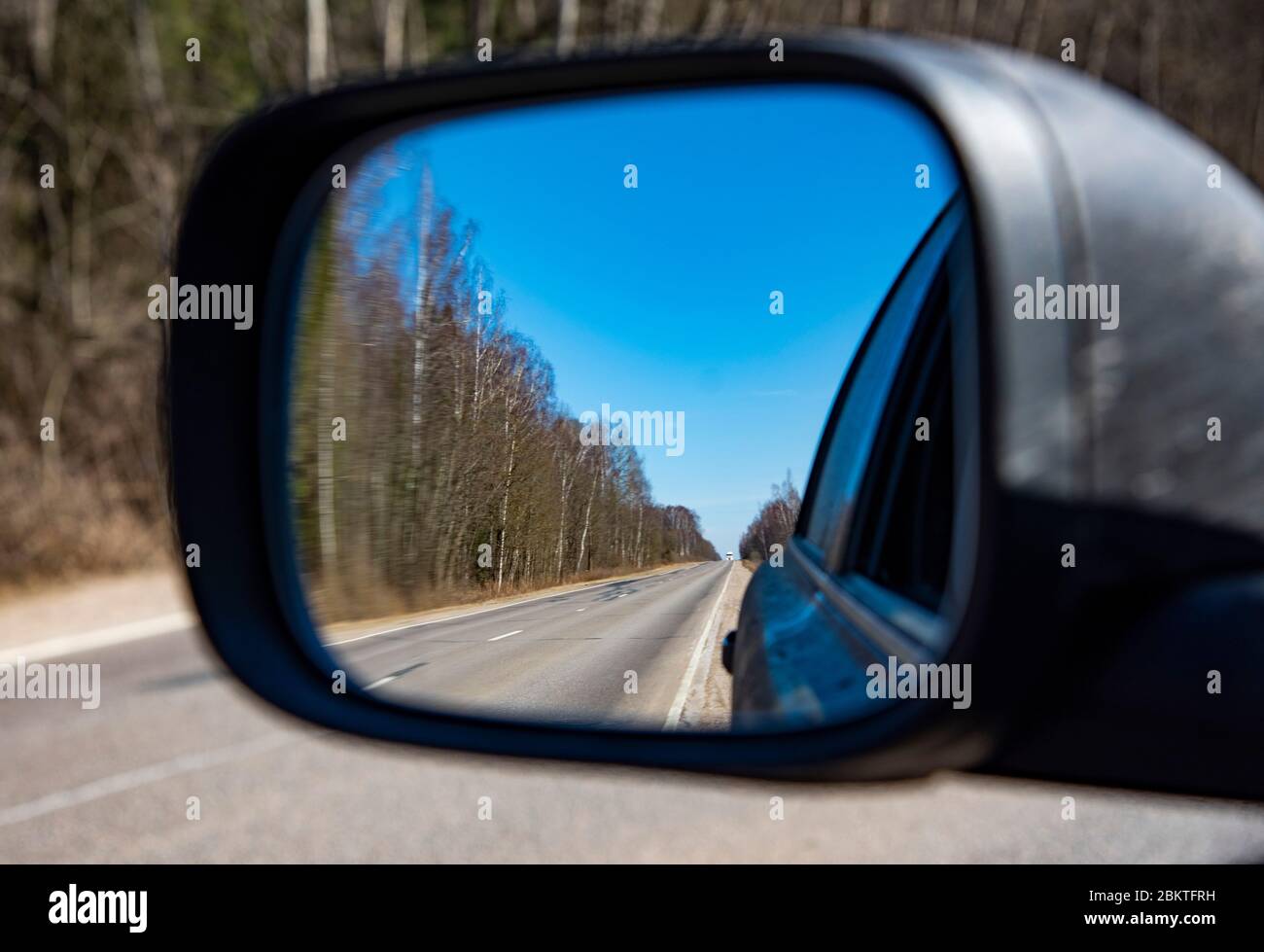 Reflection of the road in the side mirror of the car Stock Photo - Alamy