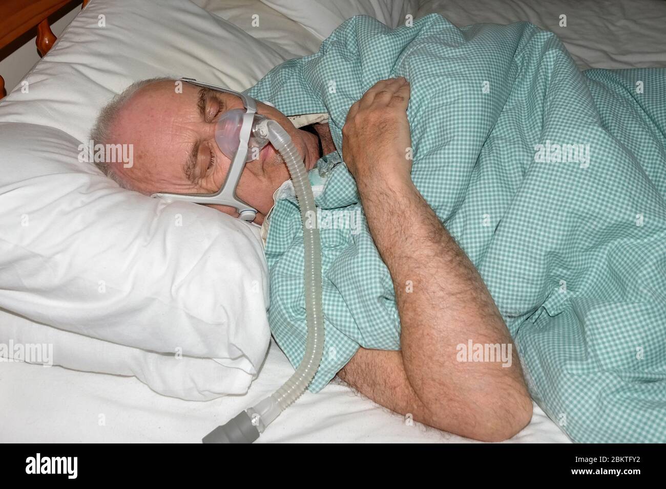 May 2020 - Mature man fast asleep wearing the mask of a CPAP sleep ...