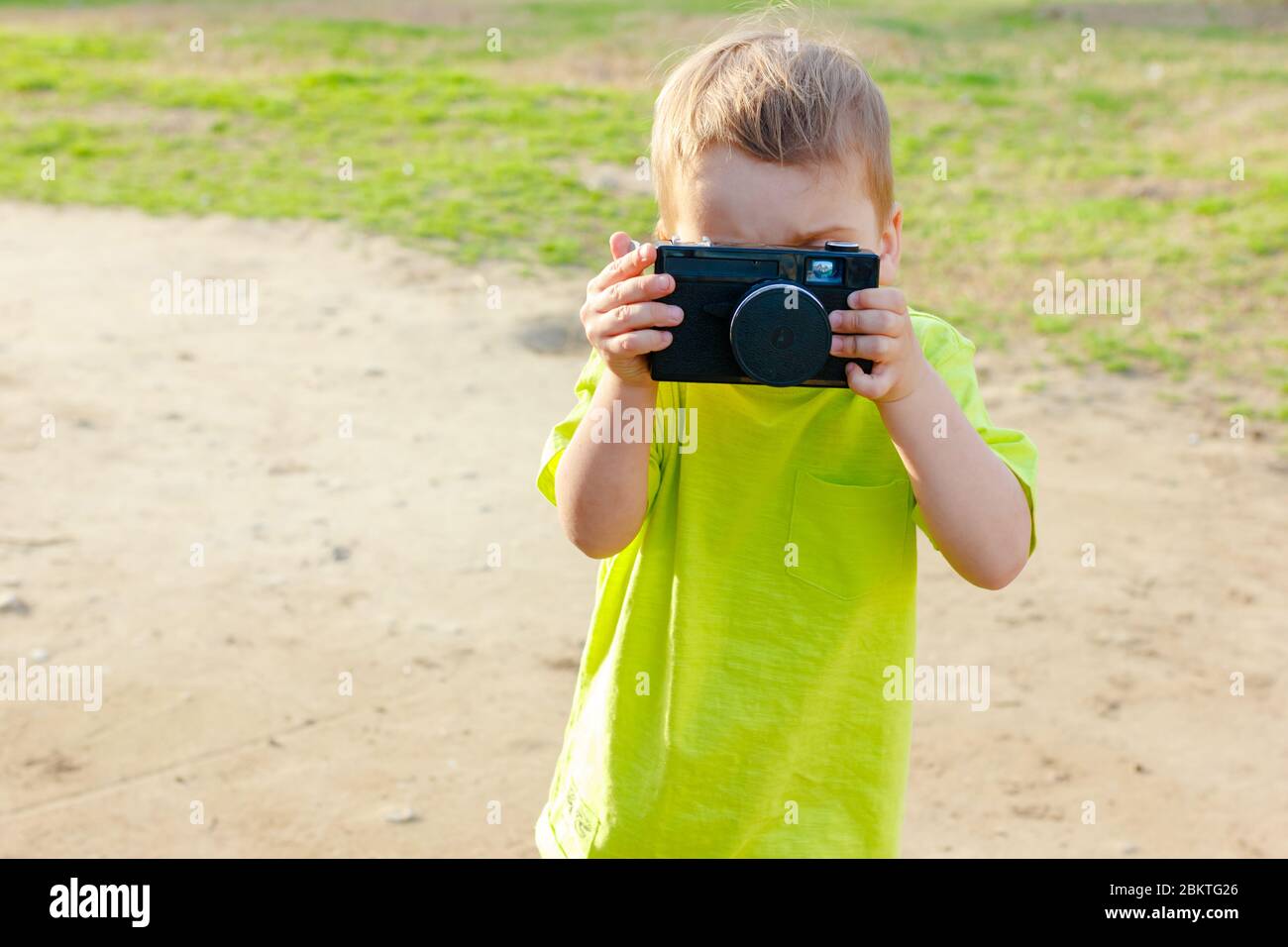 Little boy using vintage camera. Cute caucasian child taking photo with ...