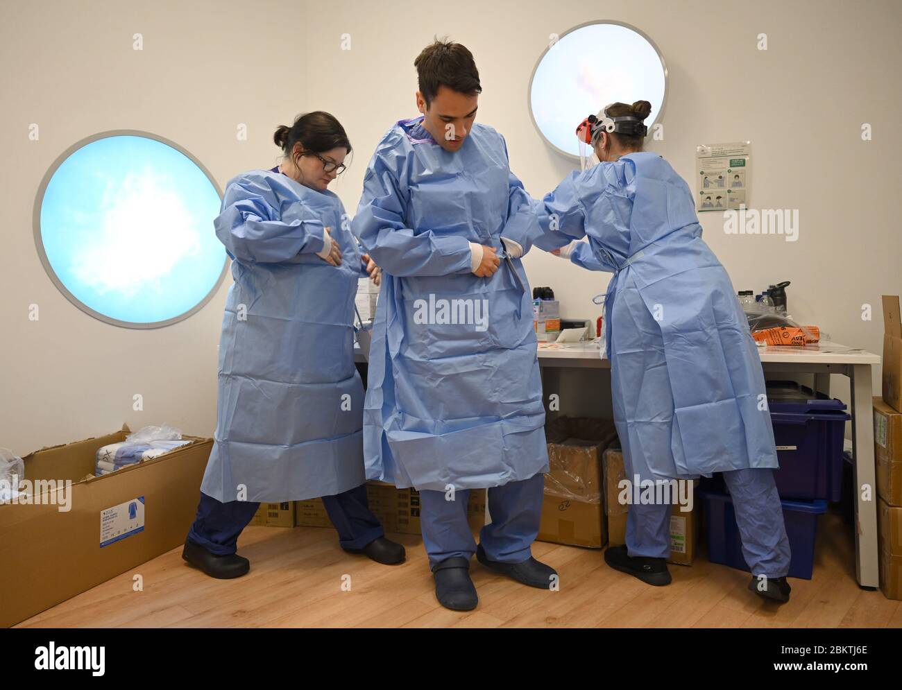 Clinical staff put on Personal Protective Equipment (PPE) at the ...