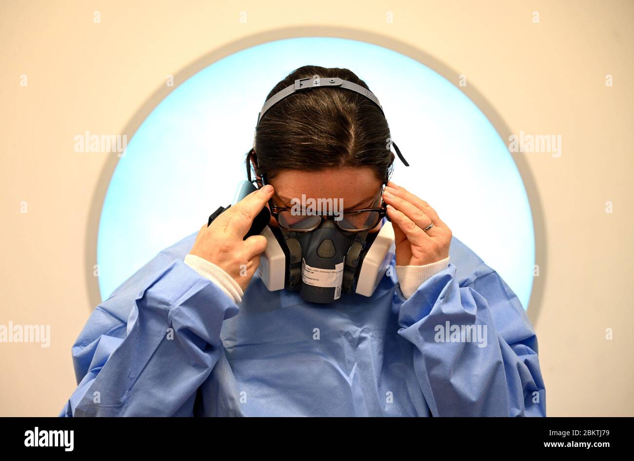 Clinical staff put on Personal Protective Equipment (PPE) at the ...