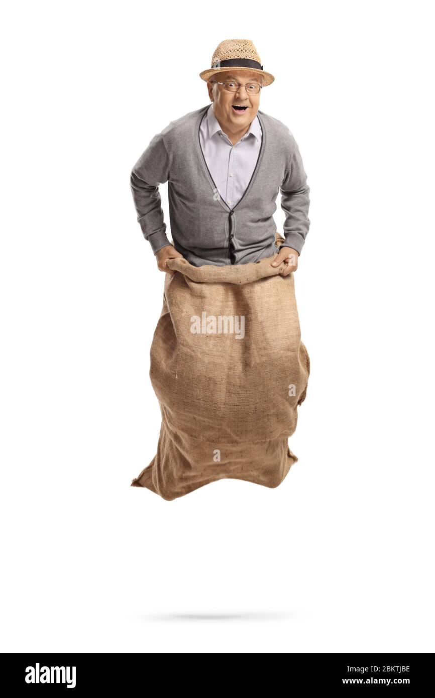 Excited elderly man jumping in a sack isolated on white background ...