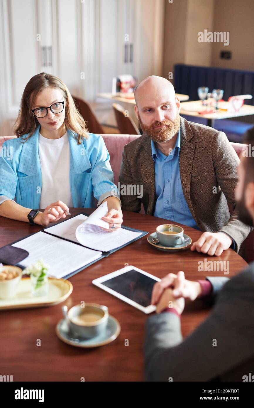Lawyer of businessman talking to business representative and examining ...