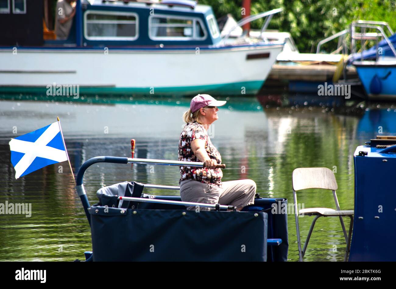 Solitary woman at the helm of a narrow boat Stock Photo - Alamy