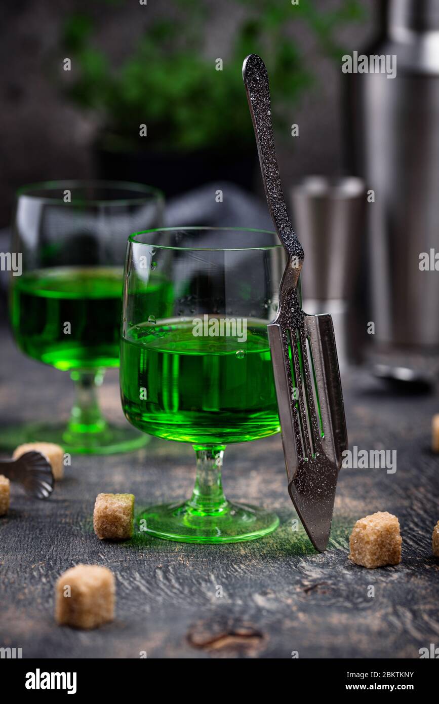 Glass of absinthe with cane sugar Stock Photo - Alamy